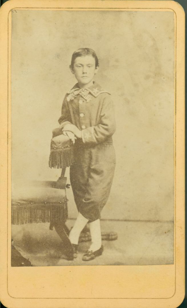 Full-length portrait of a boy, standing, facing front, location unknown ...