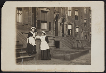 Three unidentified maids standing in front of a building in the South ...