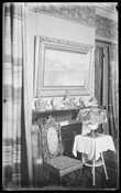 Corner of room, frilly lamp, ornate chair, painting, and objects on ...