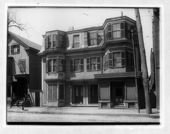 View of a three-story residential building with three entrances ...