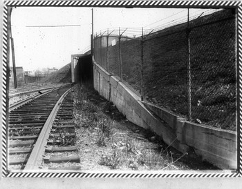 Railroad tracks with a rising chain link fence on the left | Historic ...